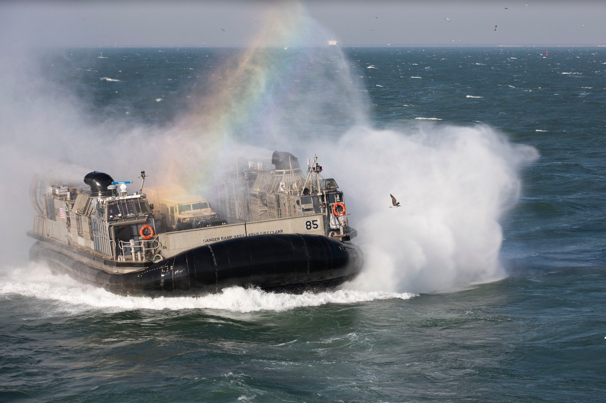U.S. Navy landing craft, air cushion transports the Ground Combat ...